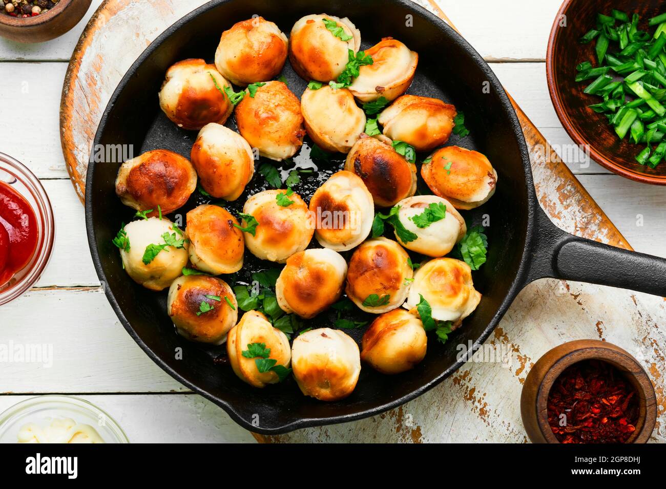 Fried dumplings stuffed with beef meat.Tasty roasted pelmeni on iron ...