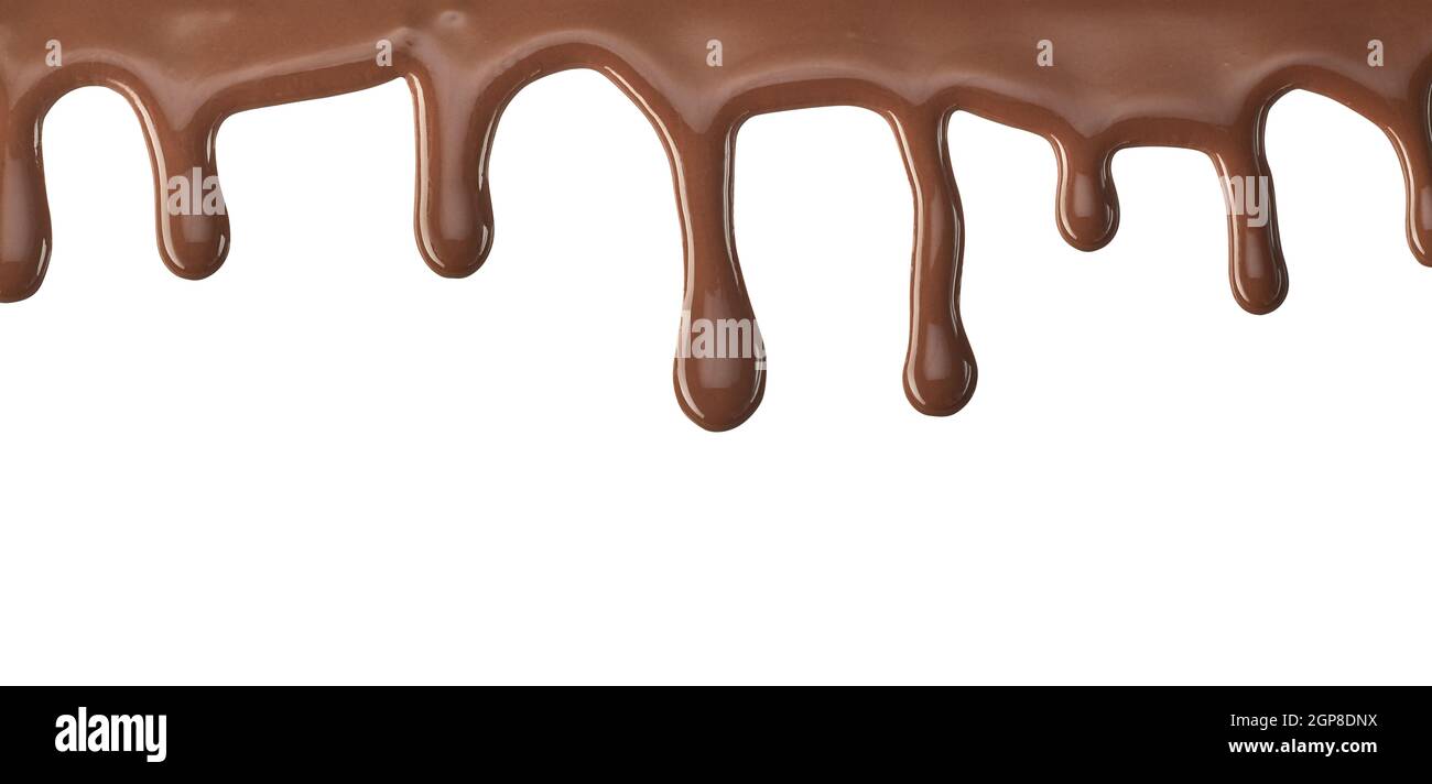 Close-up of liquid milk chocolate dripping from the top on white ...