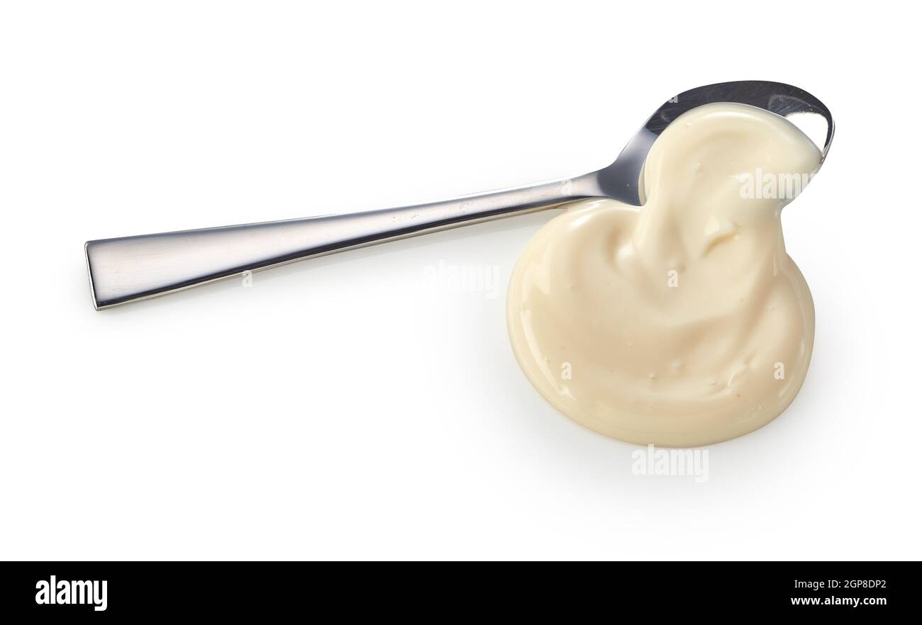 Spooned blob of creamy mayonnaise spilling on to a white background ...