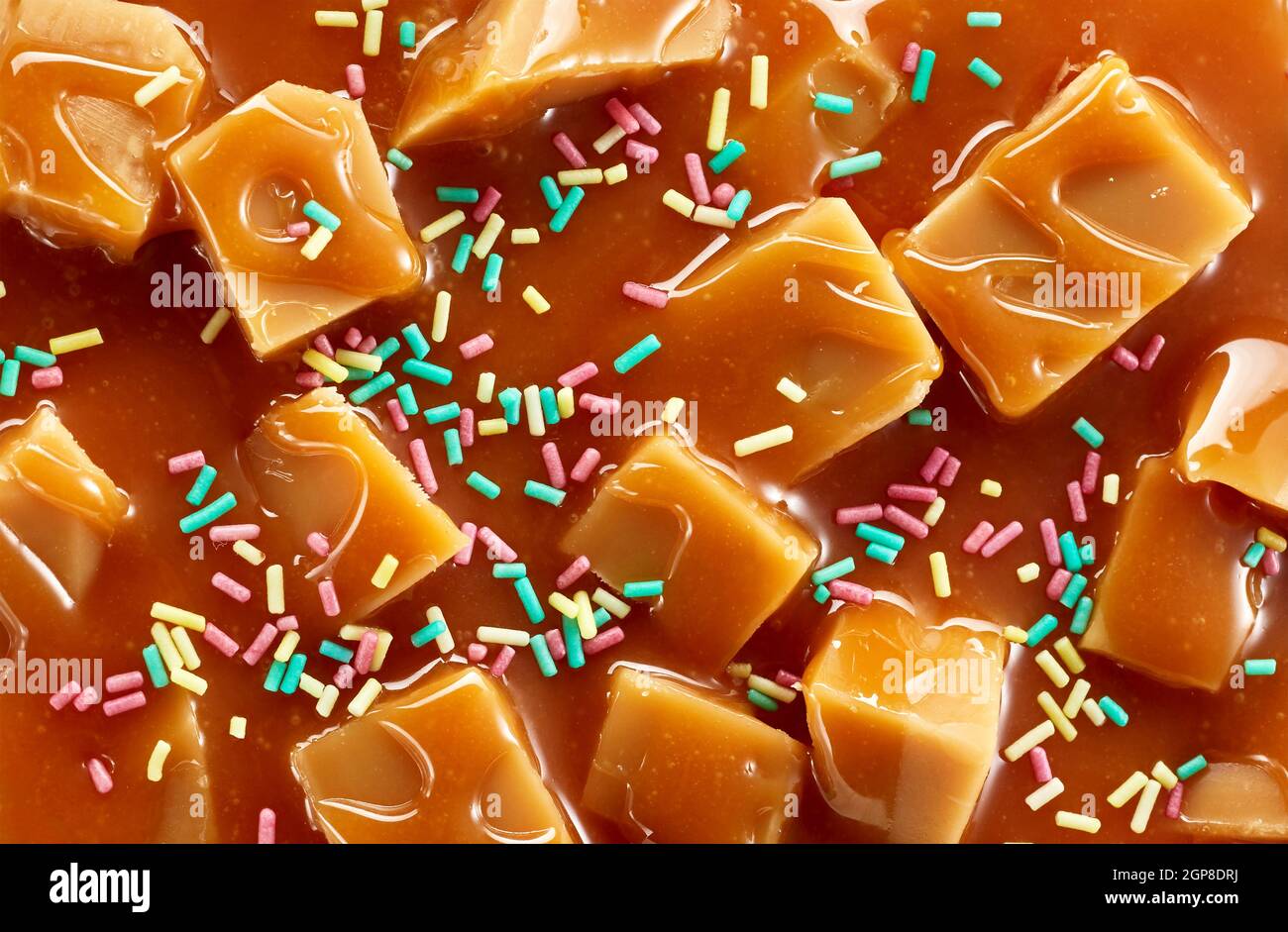 Close up Splash of caramel sauce with fudge candies.Top view of sweet ...