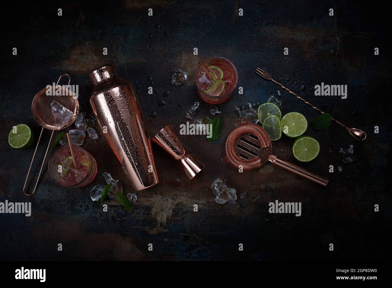 Cocktails, bar or pub background with served drinks, copper shaker and ...