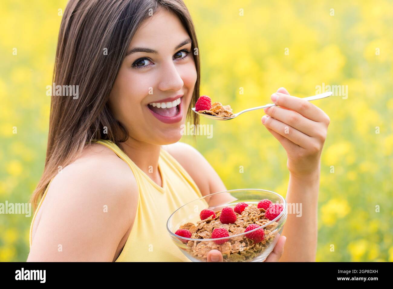 Close up face shot of attractive young woman eating healthy crispy ...