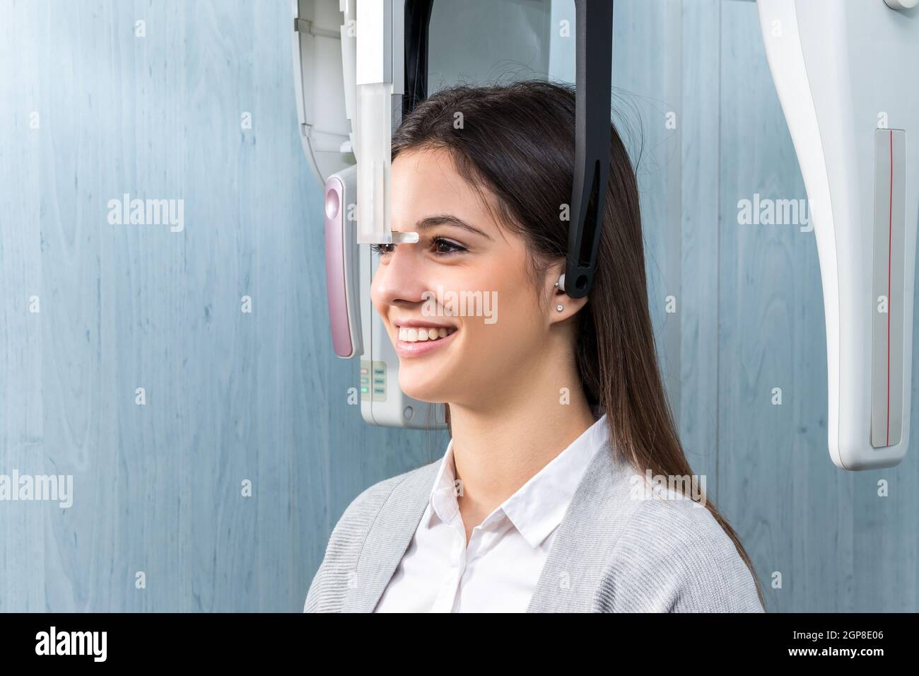 Close up portrait of young female dental patient standing in digital ...