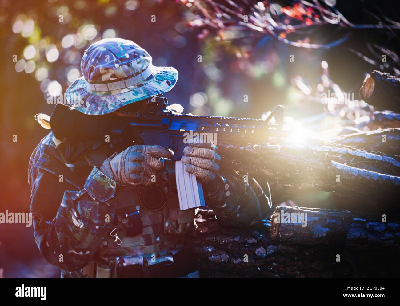 Airsoft military game player in camouflage uniform with armed assault ...