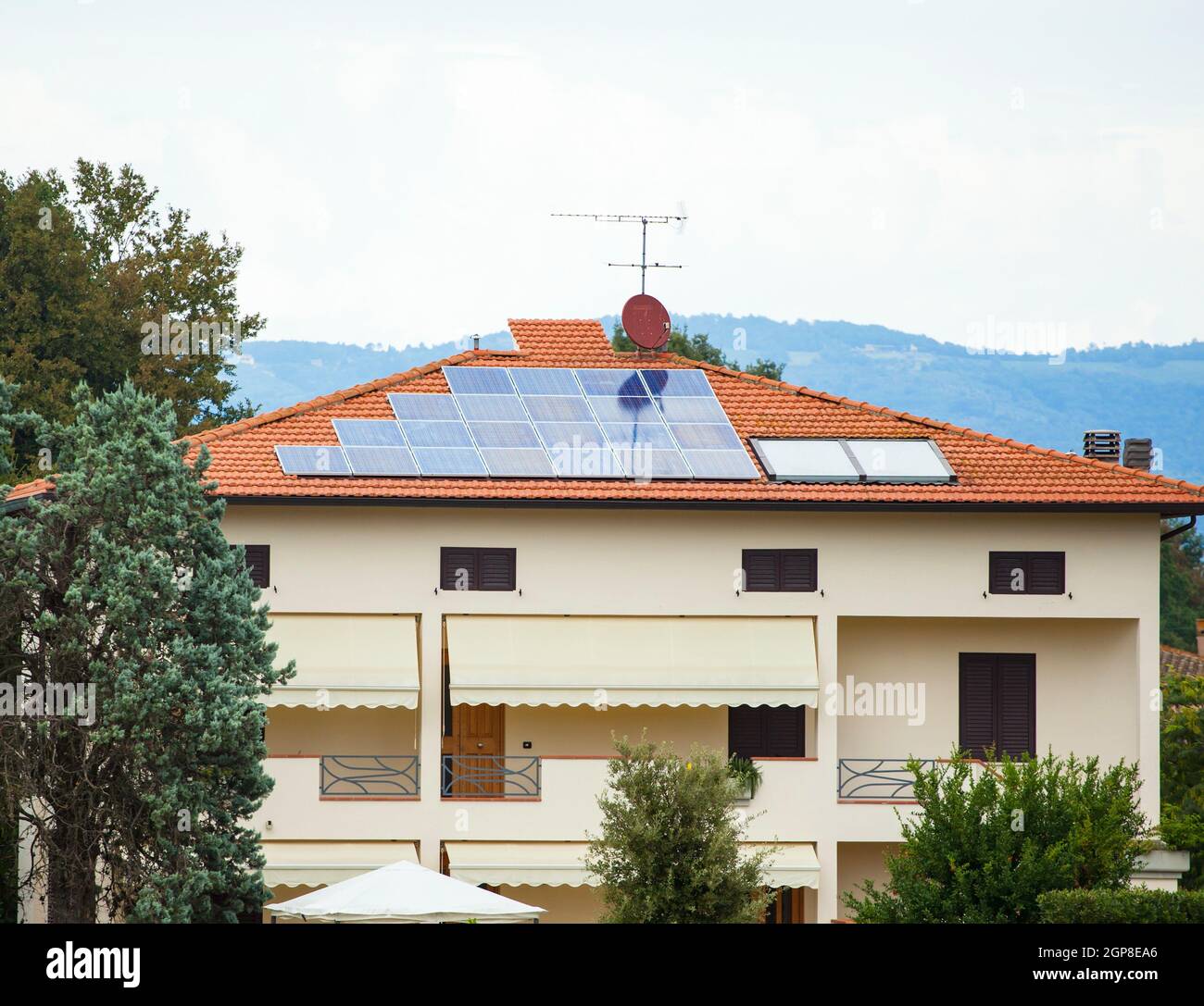 Photovoltaic solar panel on a roof. In background gray cloudy sky Stock ...