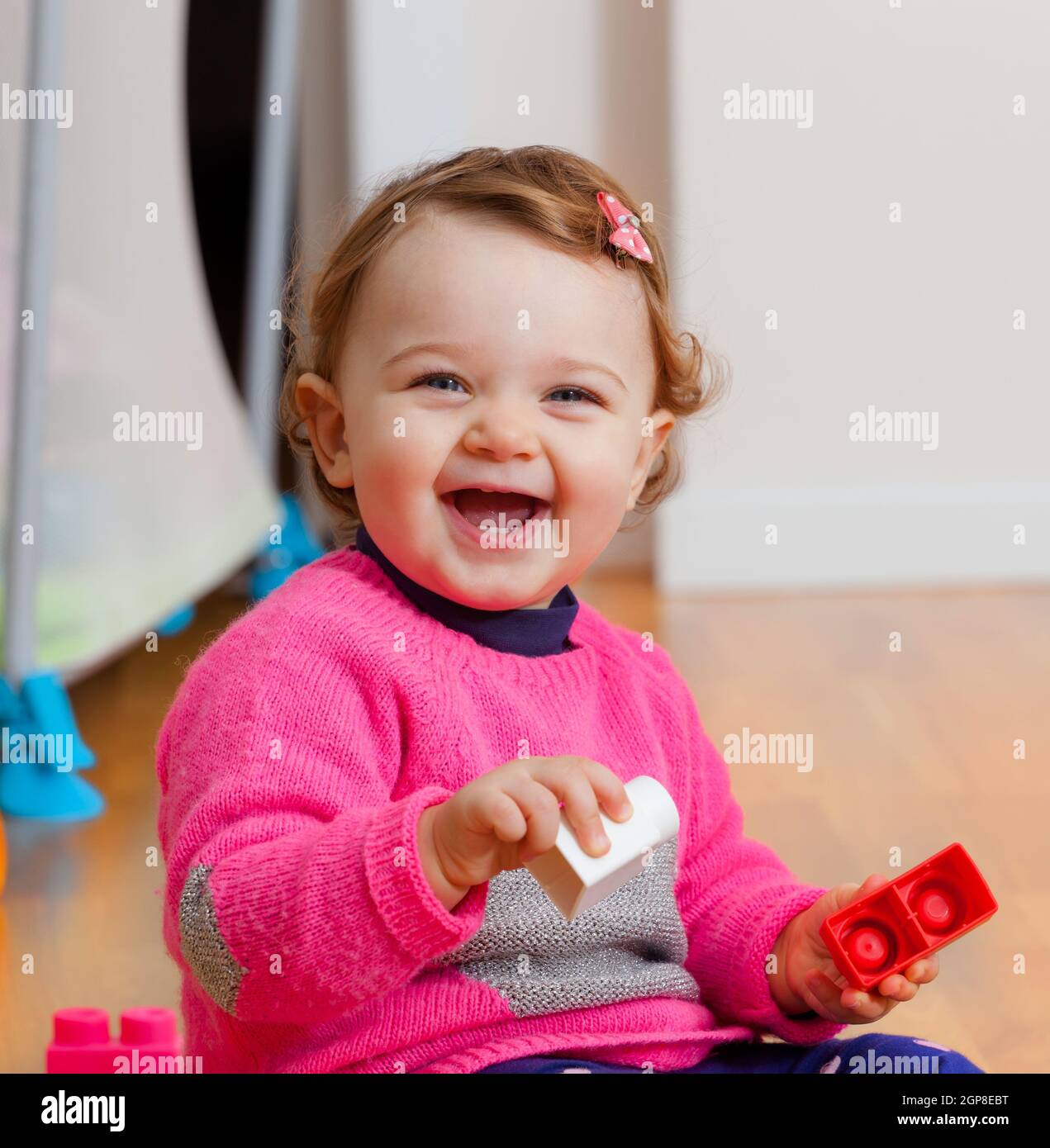 Toddler baby girl plays with soft rubber building blocks Stock Photo ...