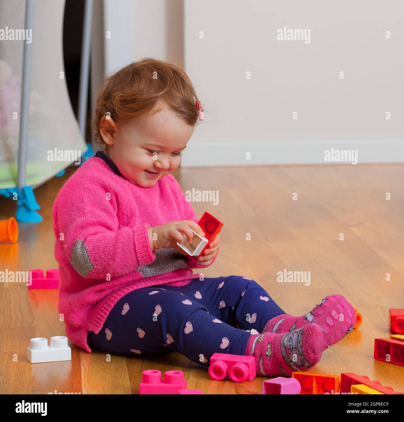 Baby girl playing colored blocks hi-res stock photography and images ...