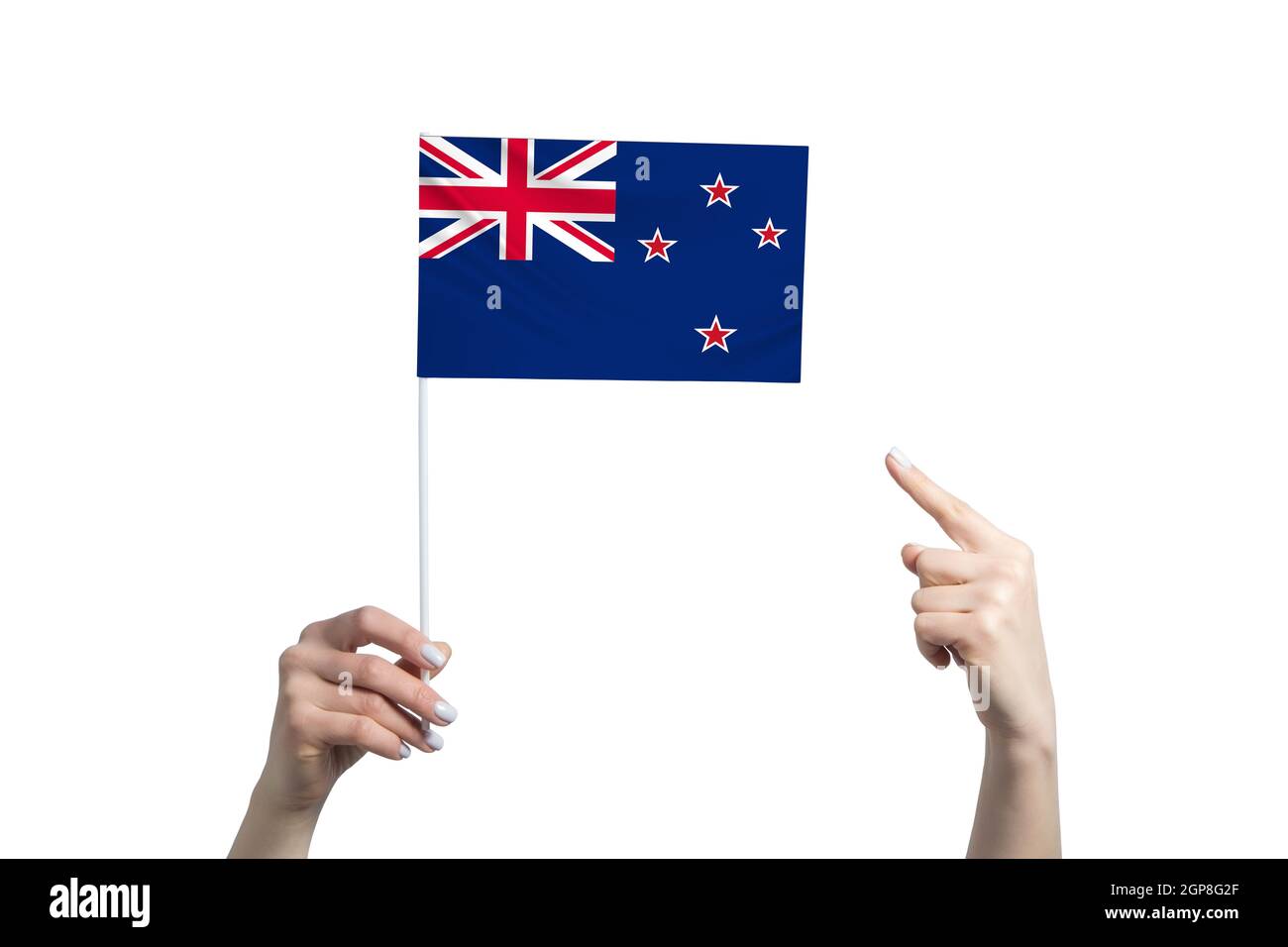 A beautiful female hand holds a New Zealand flag to which she shows the ...