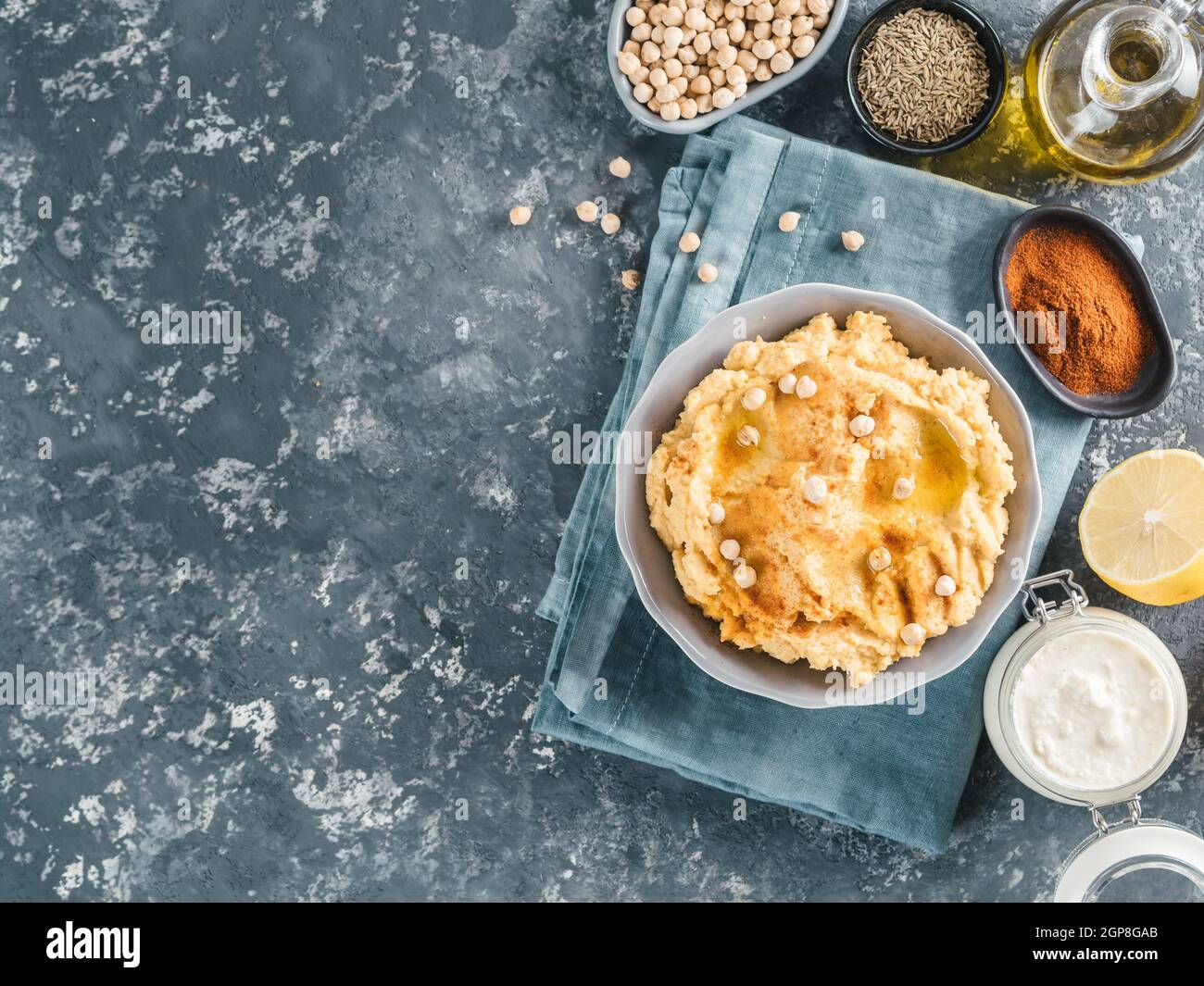 Homemade hummus in gray bowl and ingredients. Traditional middle ...