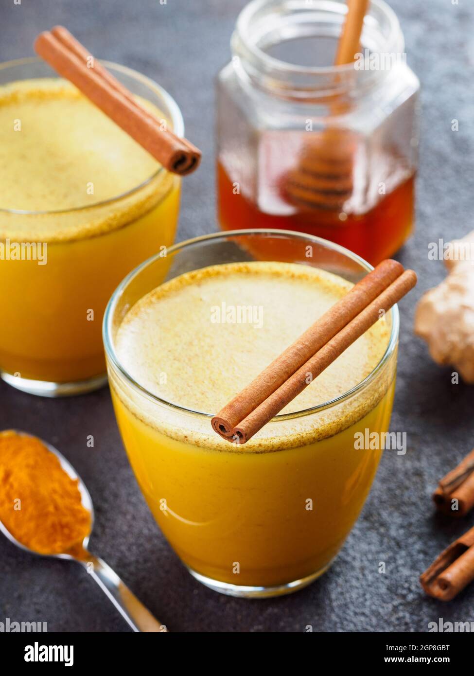 Healthy drink golden turmeric latte in glass.Gold milk with turmeric ...