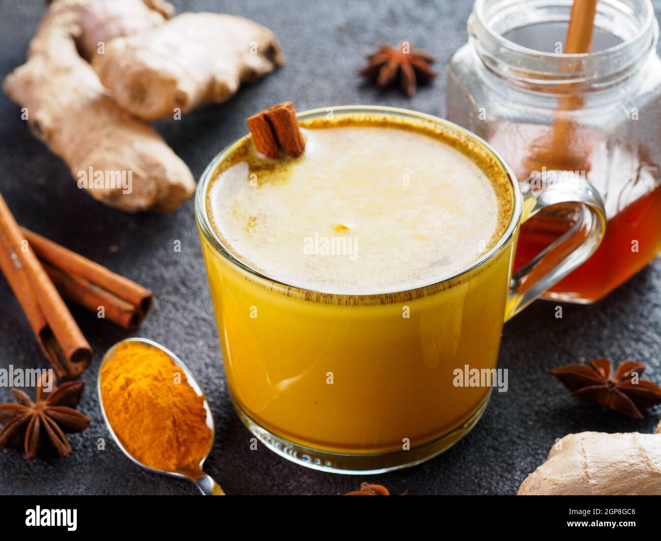 Healthy drink golden turmeric latte in glass cup.Gold milk with ...