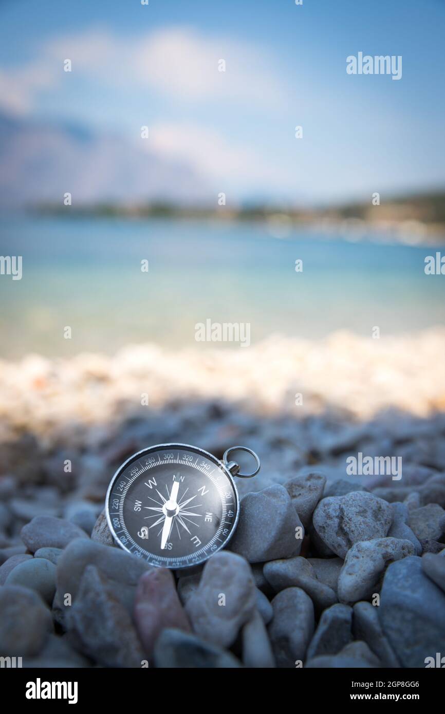 Navigation: close up of a compass lying on a pebble beach Stock Photo ...