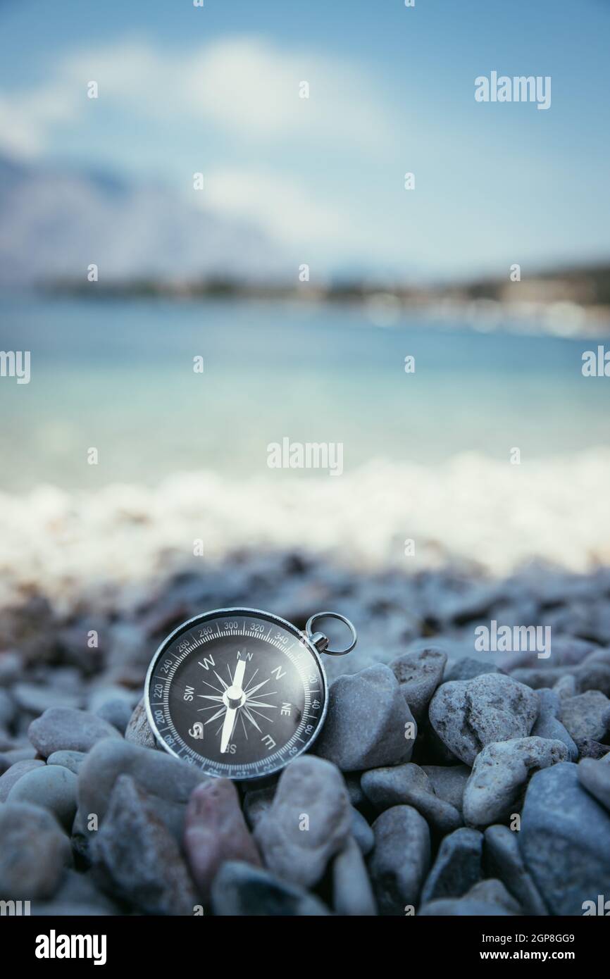 Navigation: close up of a compass lying on a pebble beach Stock Photo ...