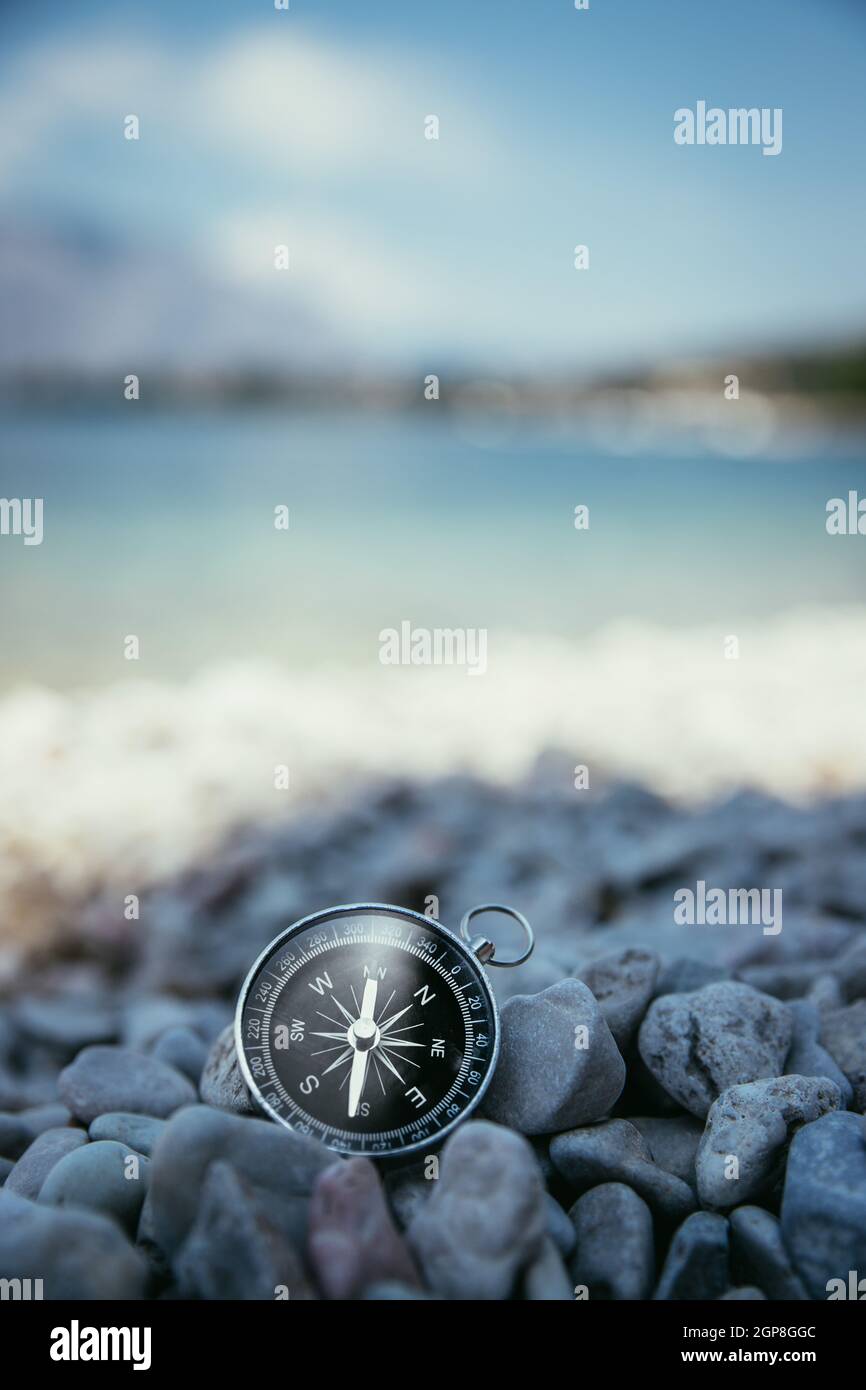 Navigation: close up of a compass lying on a pebble beach Stock Photo ...