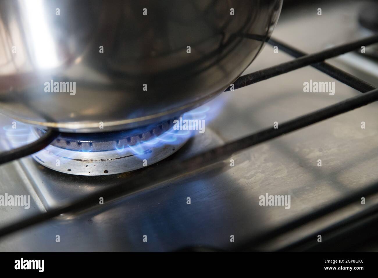 Close up of a blue gas flame, cooking a water pot in kitchen Stock ...