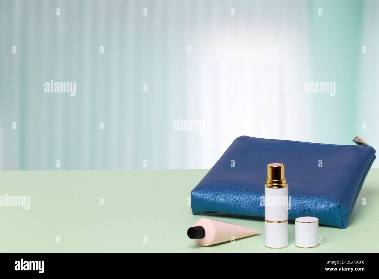 Decorative composition of a female blue cosmetic travel bag and bottles ...