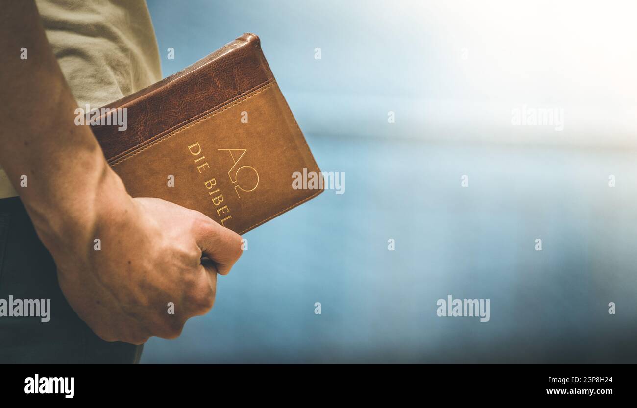 Young preacher is holding the holy bible, praying Stock Photo - Alamy