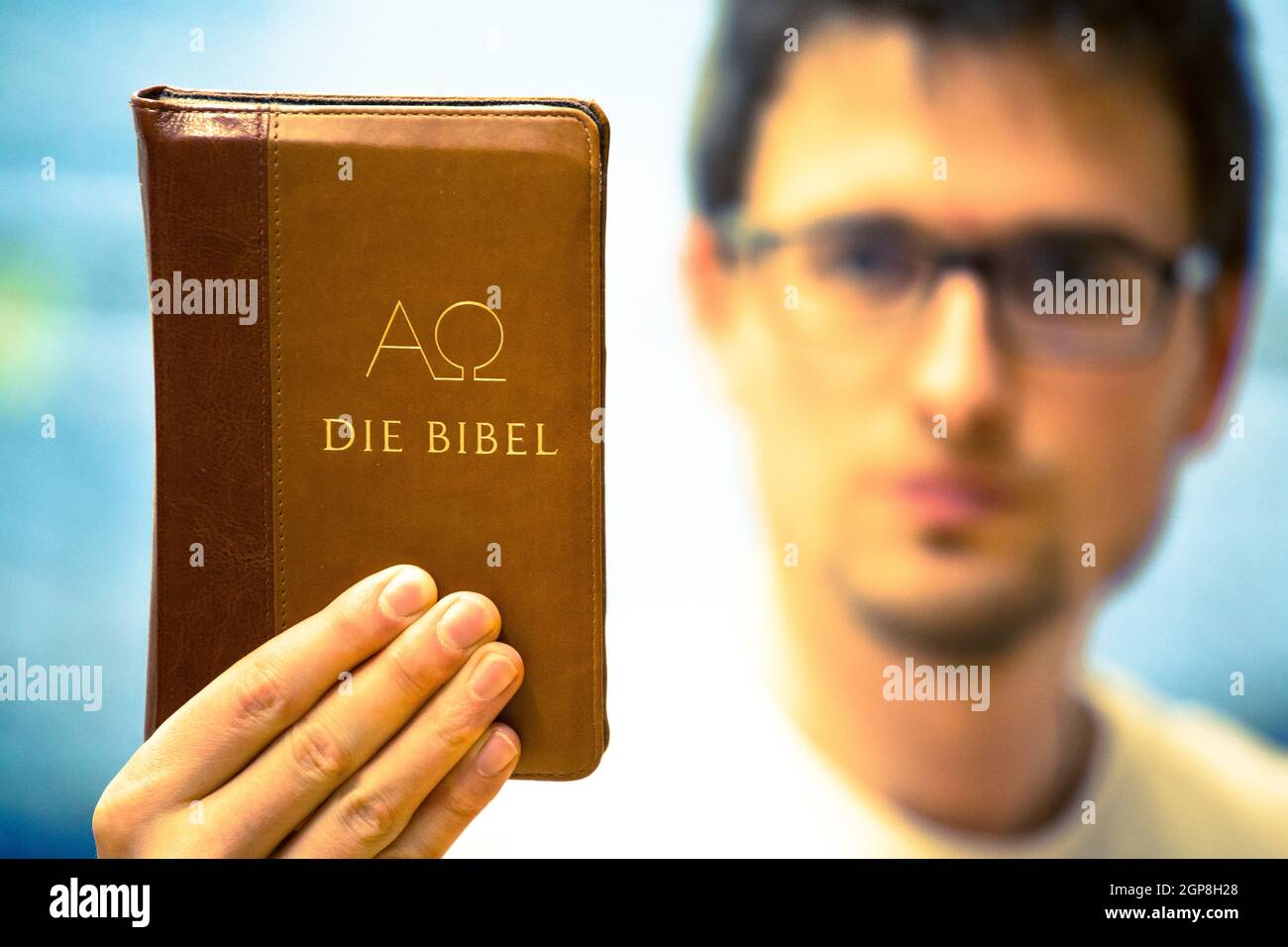 Young preacher is holding the holy bible, praying Stock Photo - Alamy