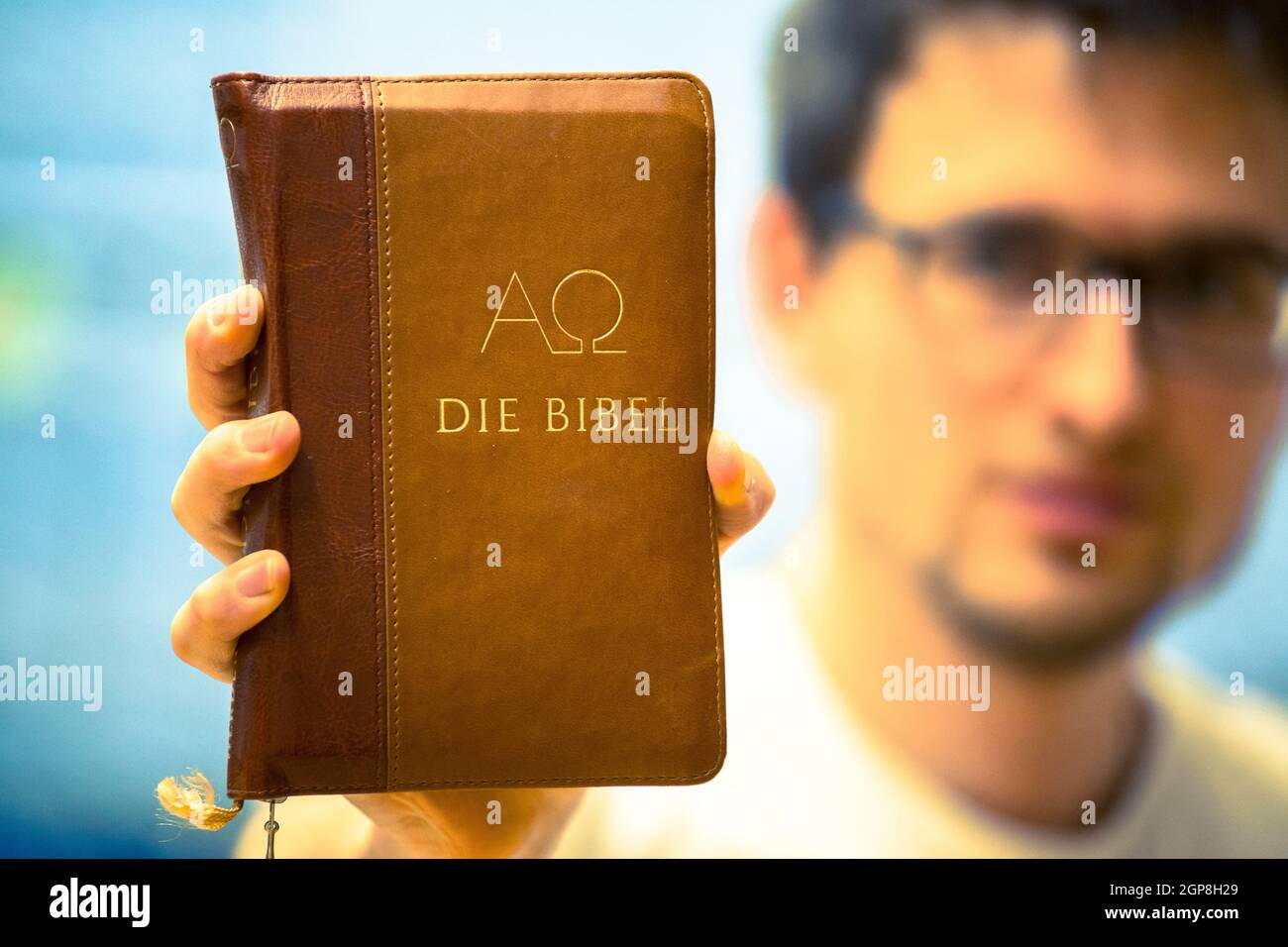 Young preacher is holding the holy bible, praying Stock Photo - Alamy