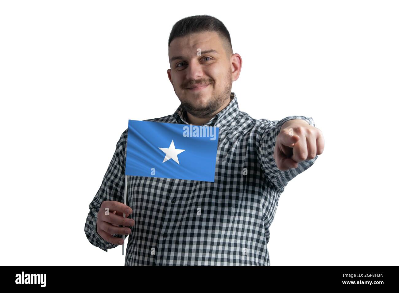 White guy holding a flag of Somalia and points forward in front of him ...