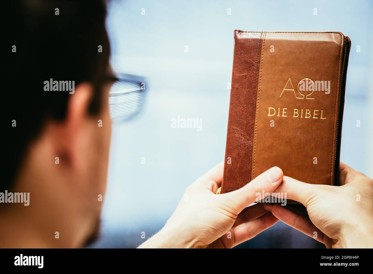 Young preacher is holding the holy bible, praying Stock Photo - Alamy
