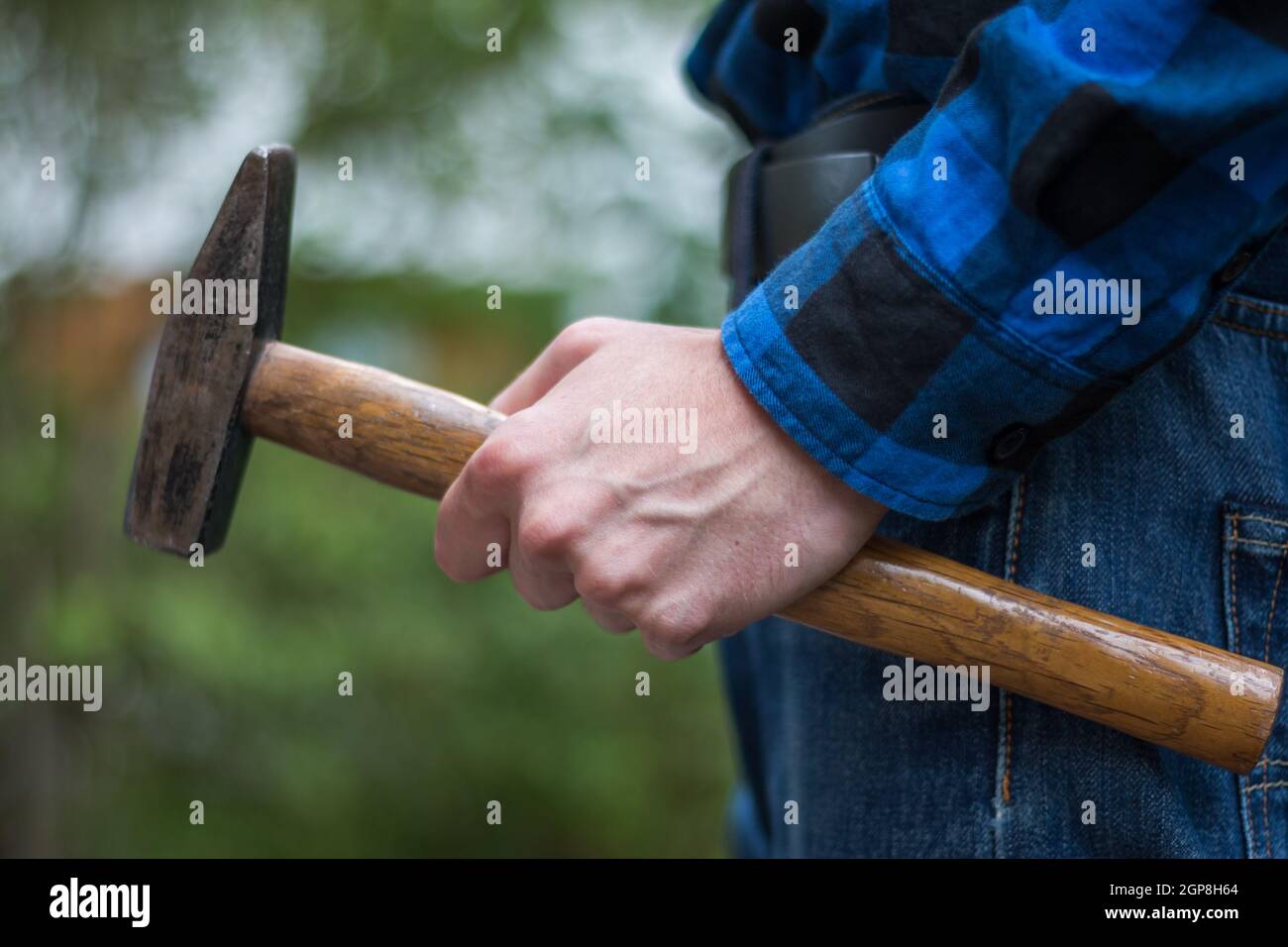 Close up picture of a craftsman with hammer in his hand Stock Photo - Alamy