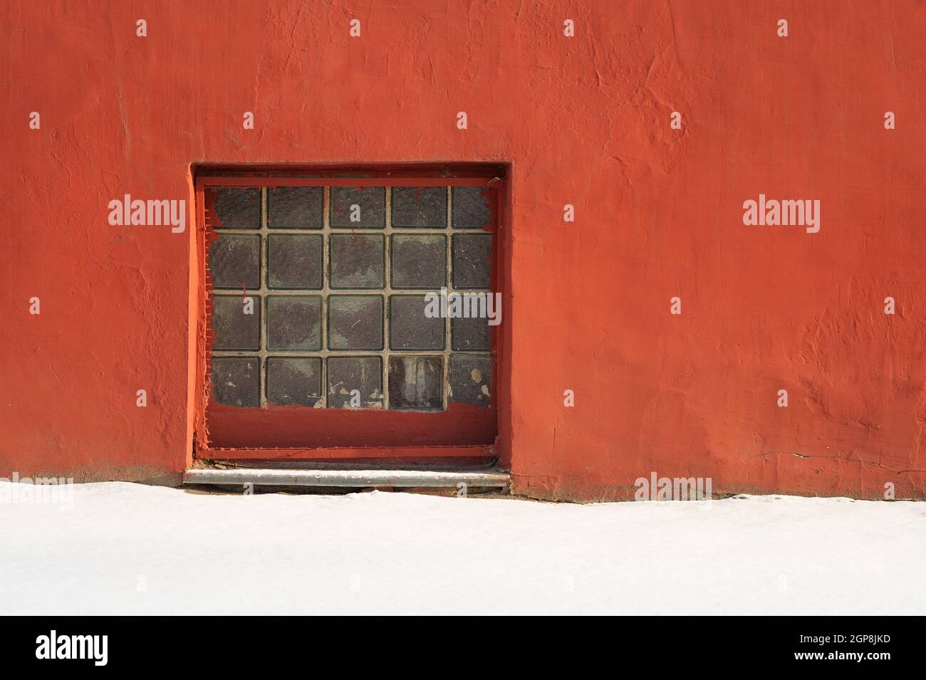 Glass brick square window in red plastered wall with copyspace ...