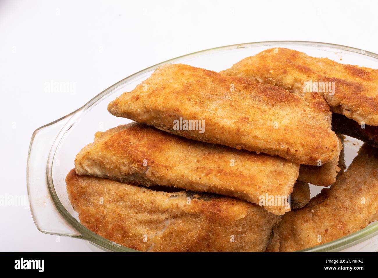 Breaded fish fillets in a glass, heat-resistant dish Stock Photo - Alamy