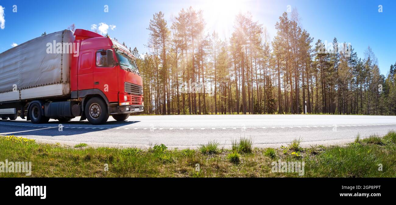Lorry on asphalt road on spring day. Truck moving on the highway in ...
