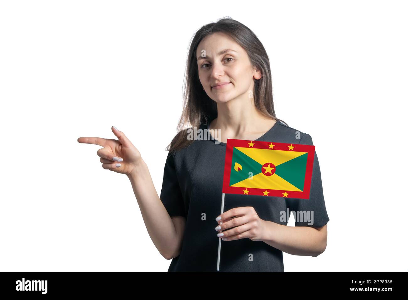 Happy young white woman holding flag Grenada and points to the left ...