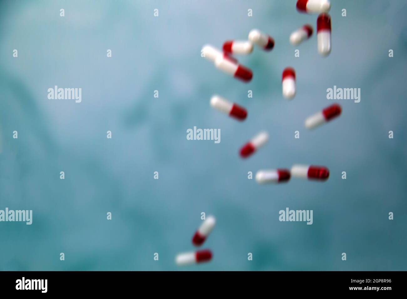 Falling medicine pills defocused blurred background, capsules for ...