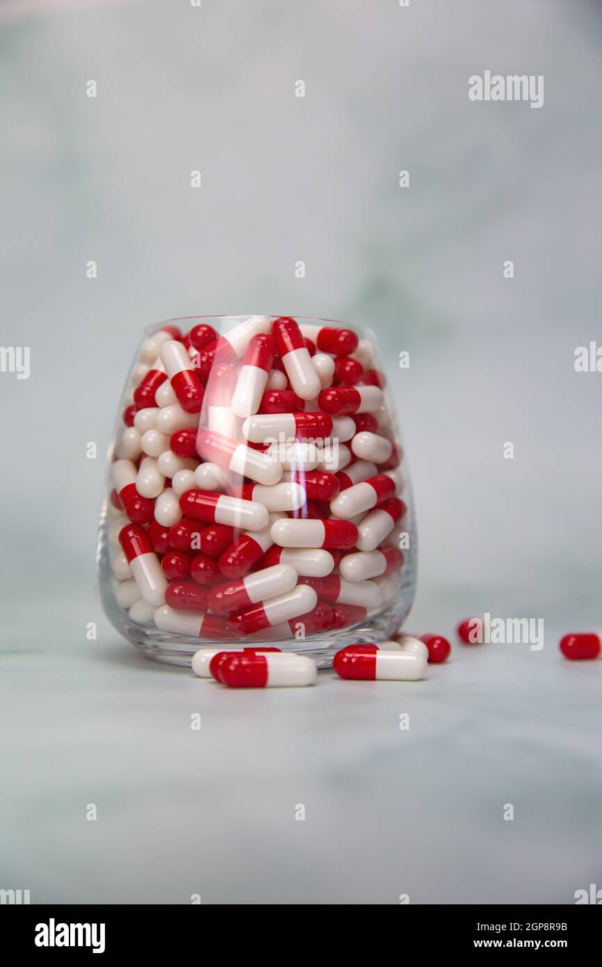 Filled glass with capsules pills for medication.drugs or vitamin ...