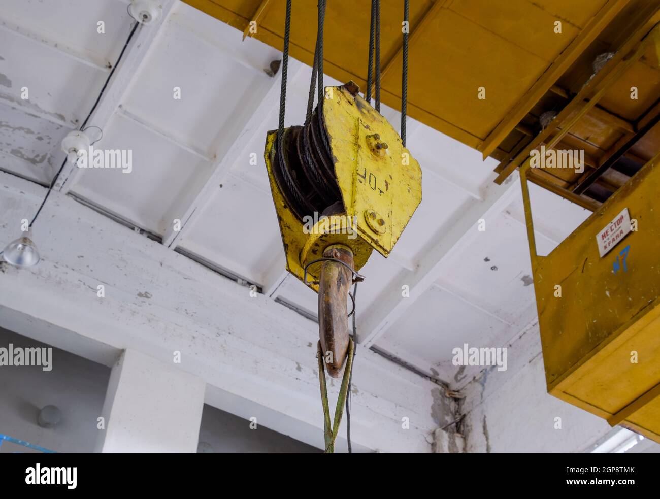 Hoist with winch and hook. A tool for moving goods in a production room ...