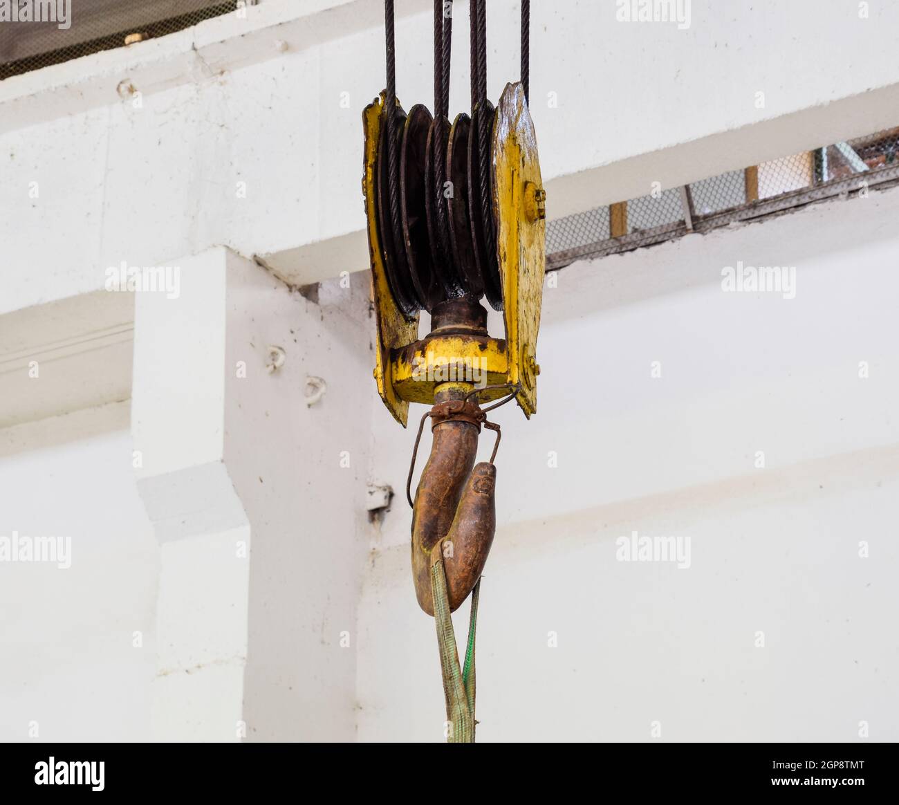 Hoist with winch and hook. A tool for moving goods in a production room ...