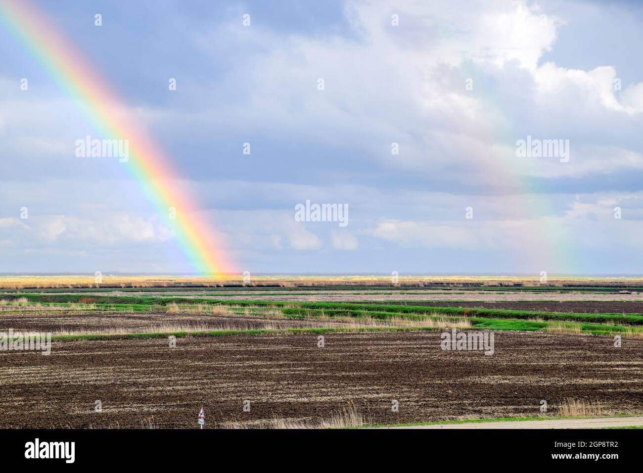 Rainbow, a view of the landscape in the field. Formation of the rainbow ...