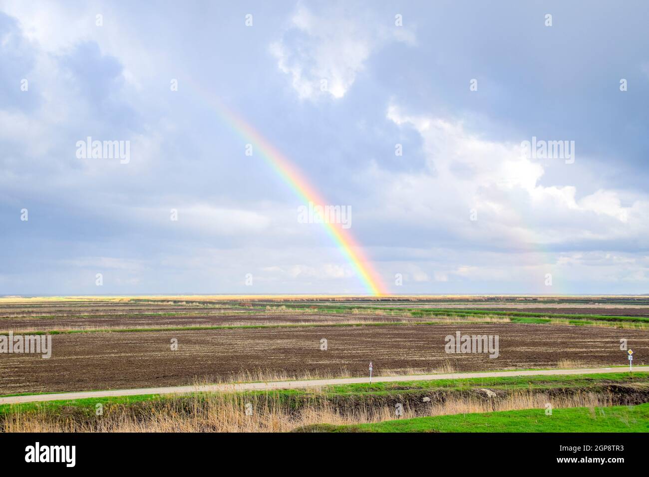 Rainbow, a view of the landscape in the field. Formation of the rainbow ...