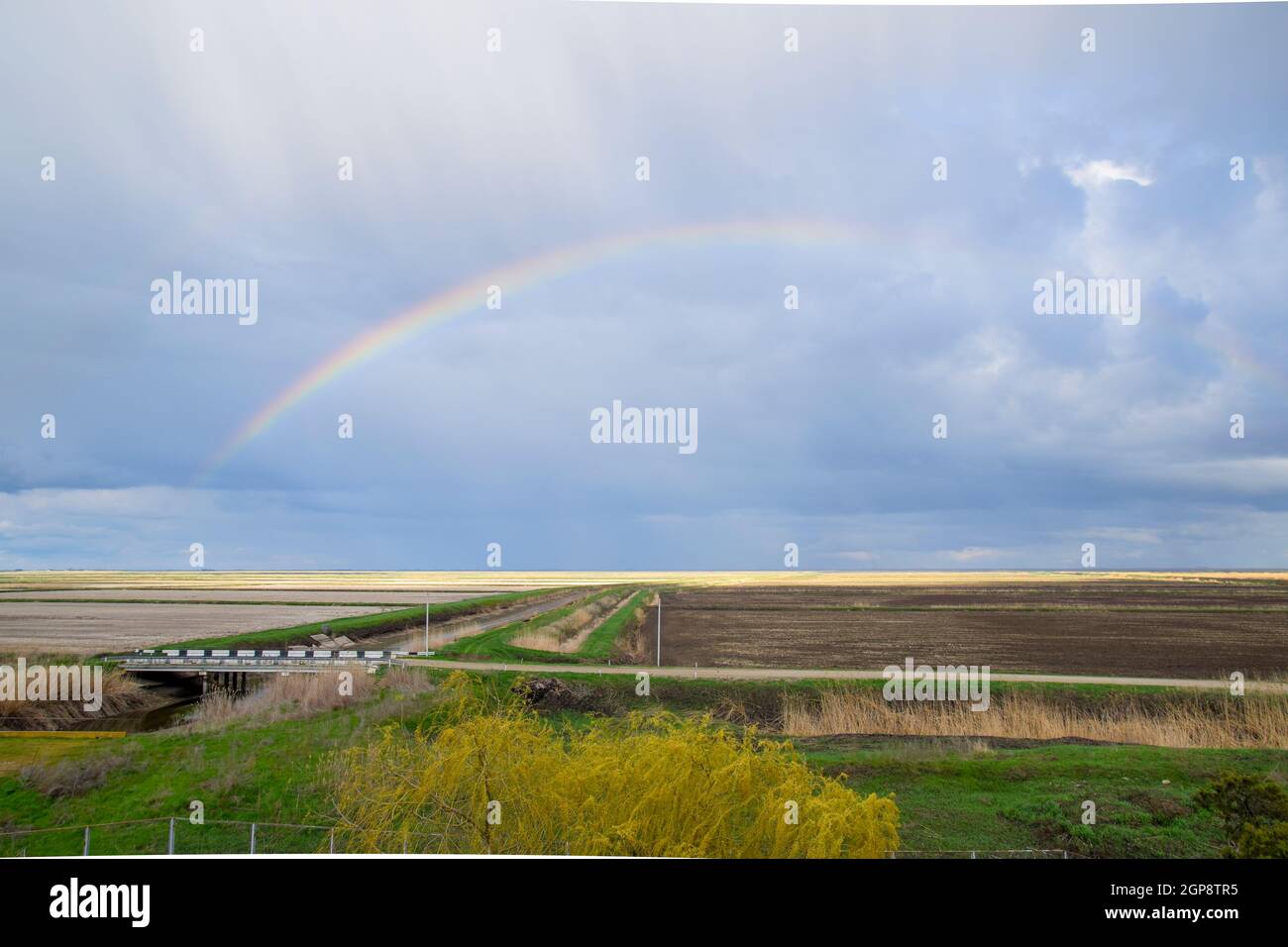 Rainbow, a view of the landscape in the field. Formation of the rainbow ...