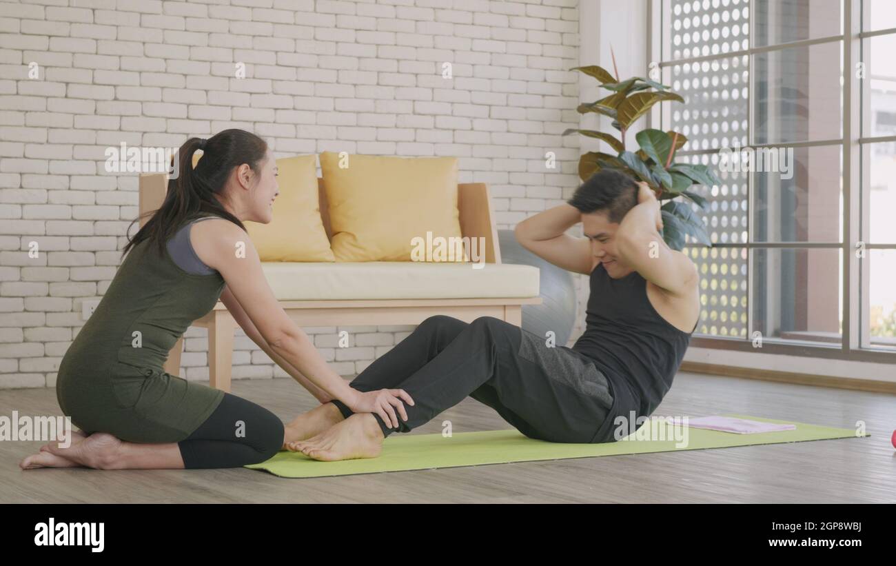 Happy Asian family couple husband and wife healthy trainer workout home ...