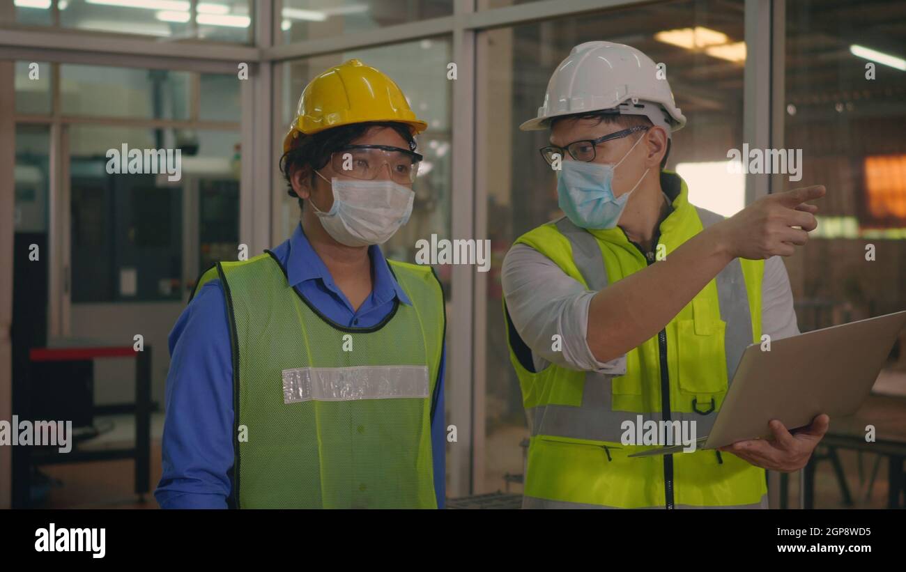 Two factory industrial workers technician or engineer worker and ...