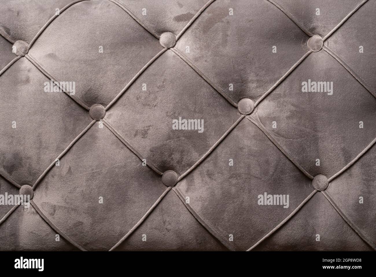 Gray velvet couch background texture with sunken buttons, detail shot ...
