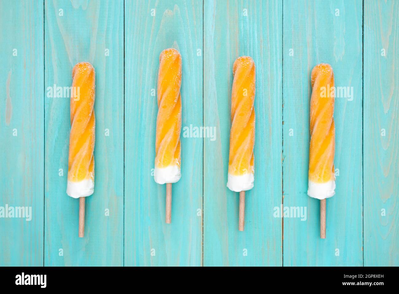 Frosty popsicles of orange in a row on a blue background Stock Photo ...