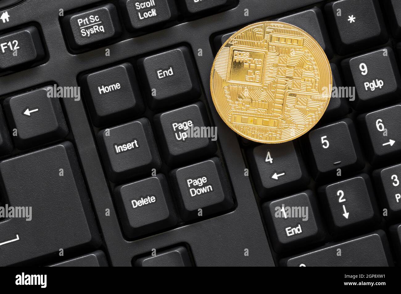 Golden BTC coin on computer keyboard.Top view Stock Photo - Alamy