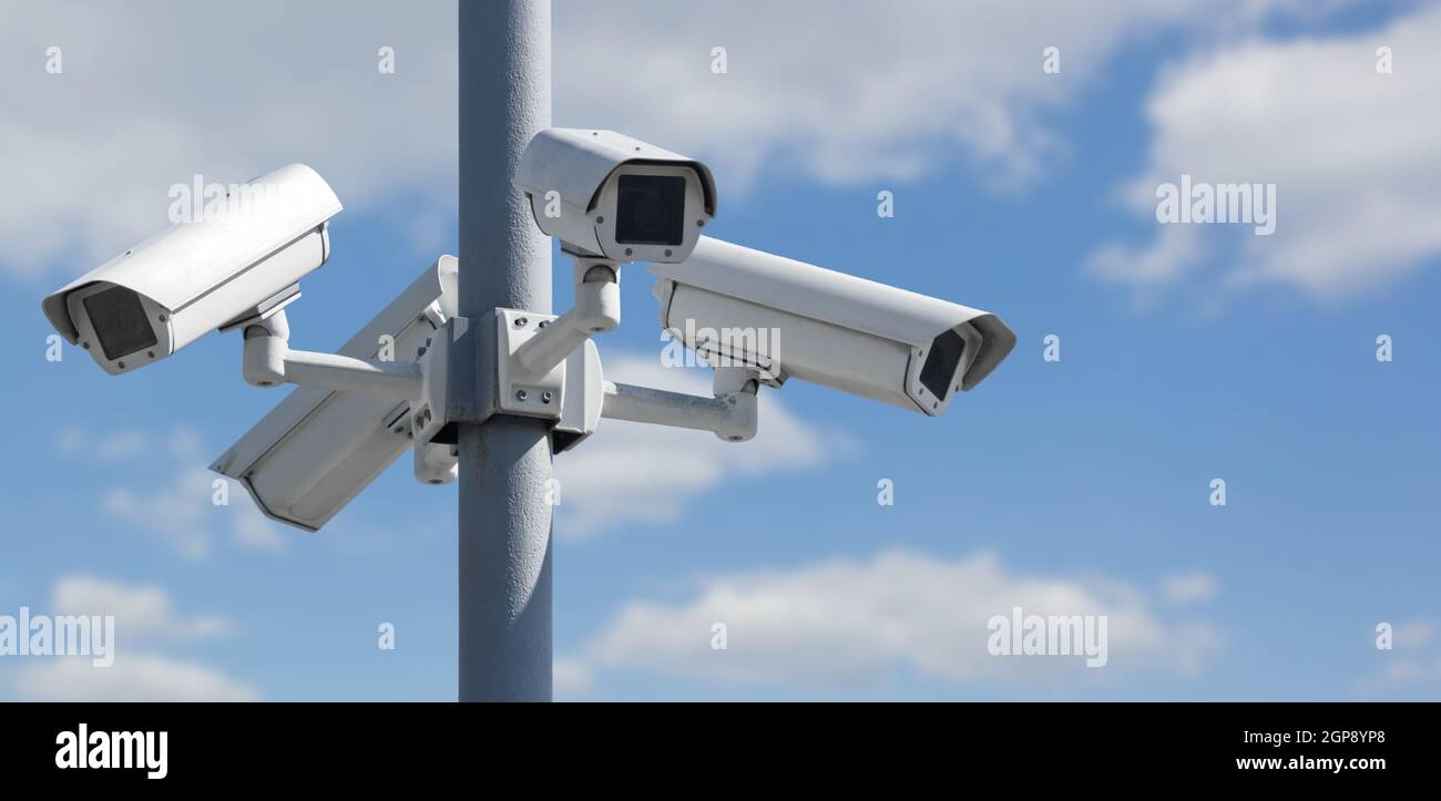 Four CCTV security cameras on a pole Stock Photo - Alamy