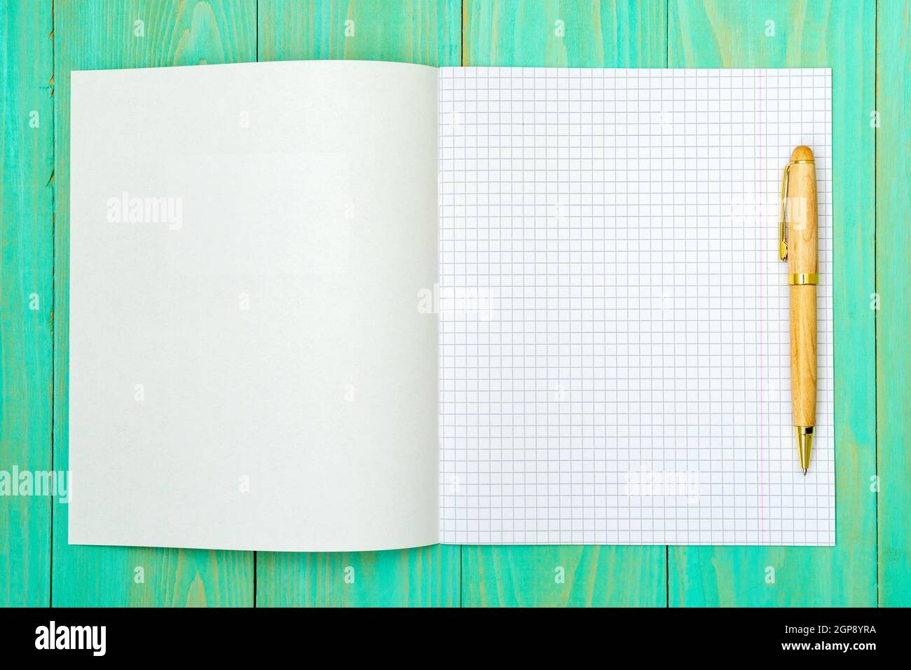 Opened squared school notebook with a pen. Copy space Stock Photo - Alamy