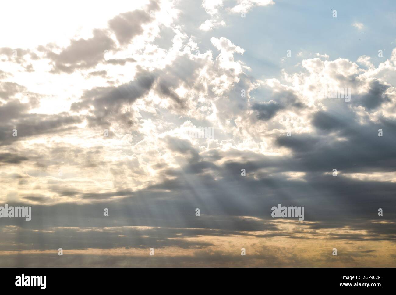 Sun rays breaking through cumulus clouds. Heavenly landscape Stock ...