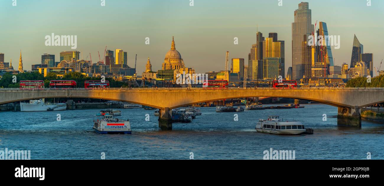 View of red buses on Waterloo Bridge, St Paul's Cathedral and The City ...