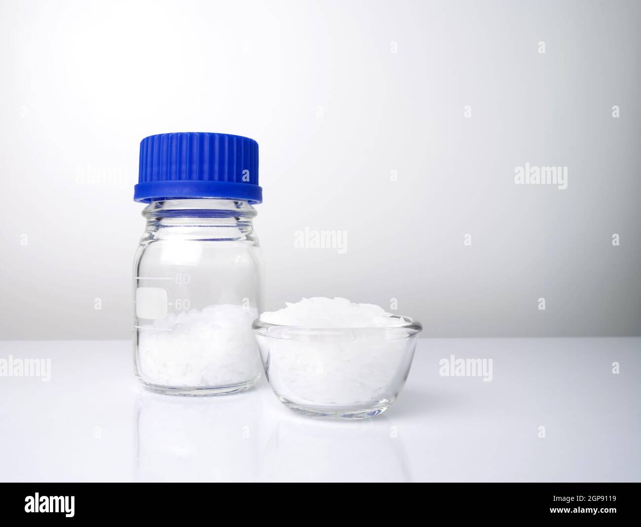 Close up White flake chemical on laboratory table. Cetyl esters wax ...