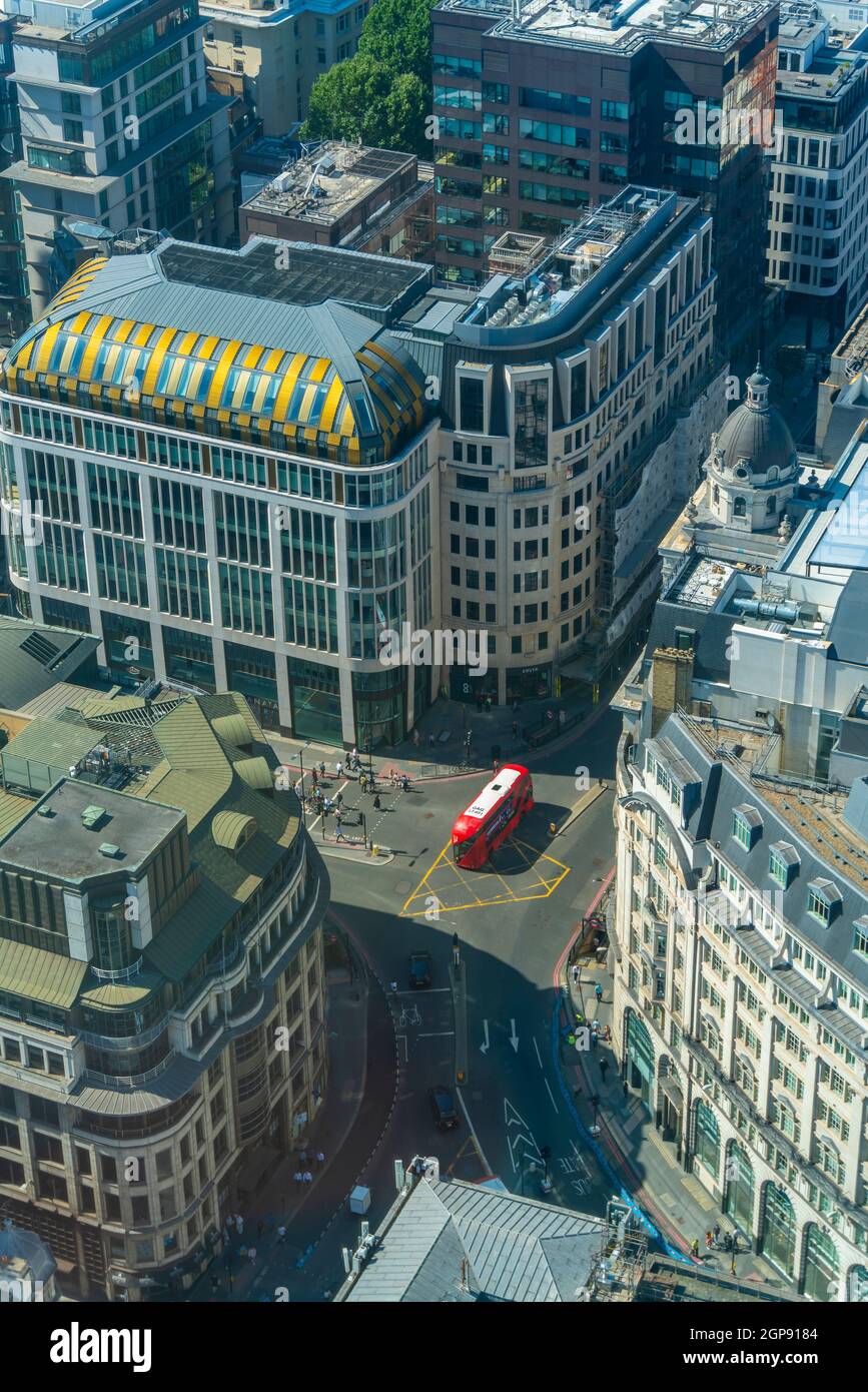 Aerial view of red bus in the City and neighbouring buildings, London ...