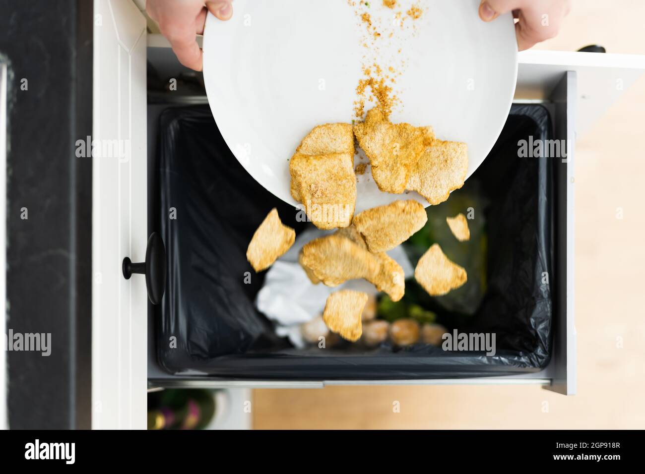 Throwing Away Leftover Food In Trash Or Garbage Dustbin Stock Photo - Alamy