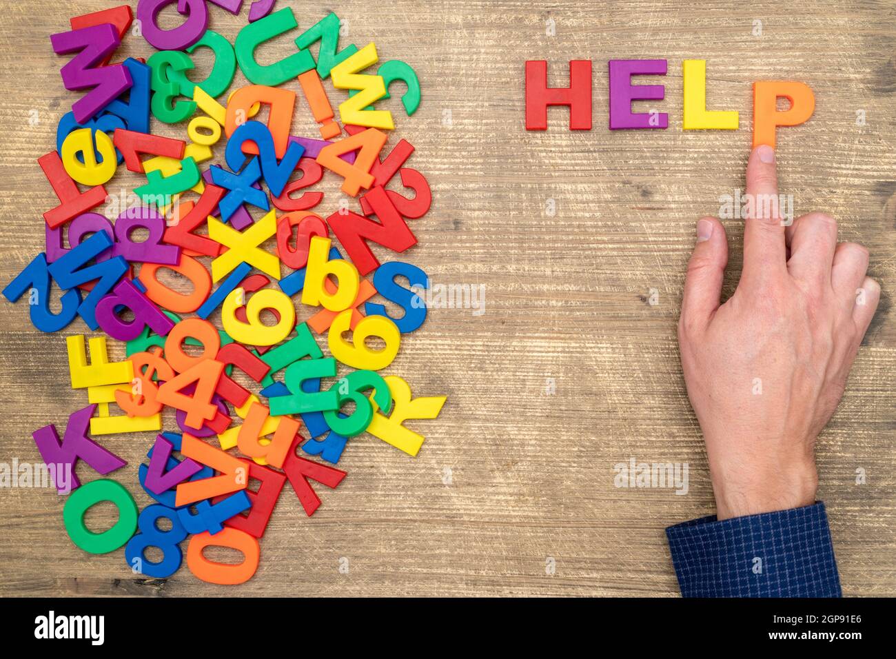 Hand adding letter P to word HELP made of plastic letters Stock Photo ...
